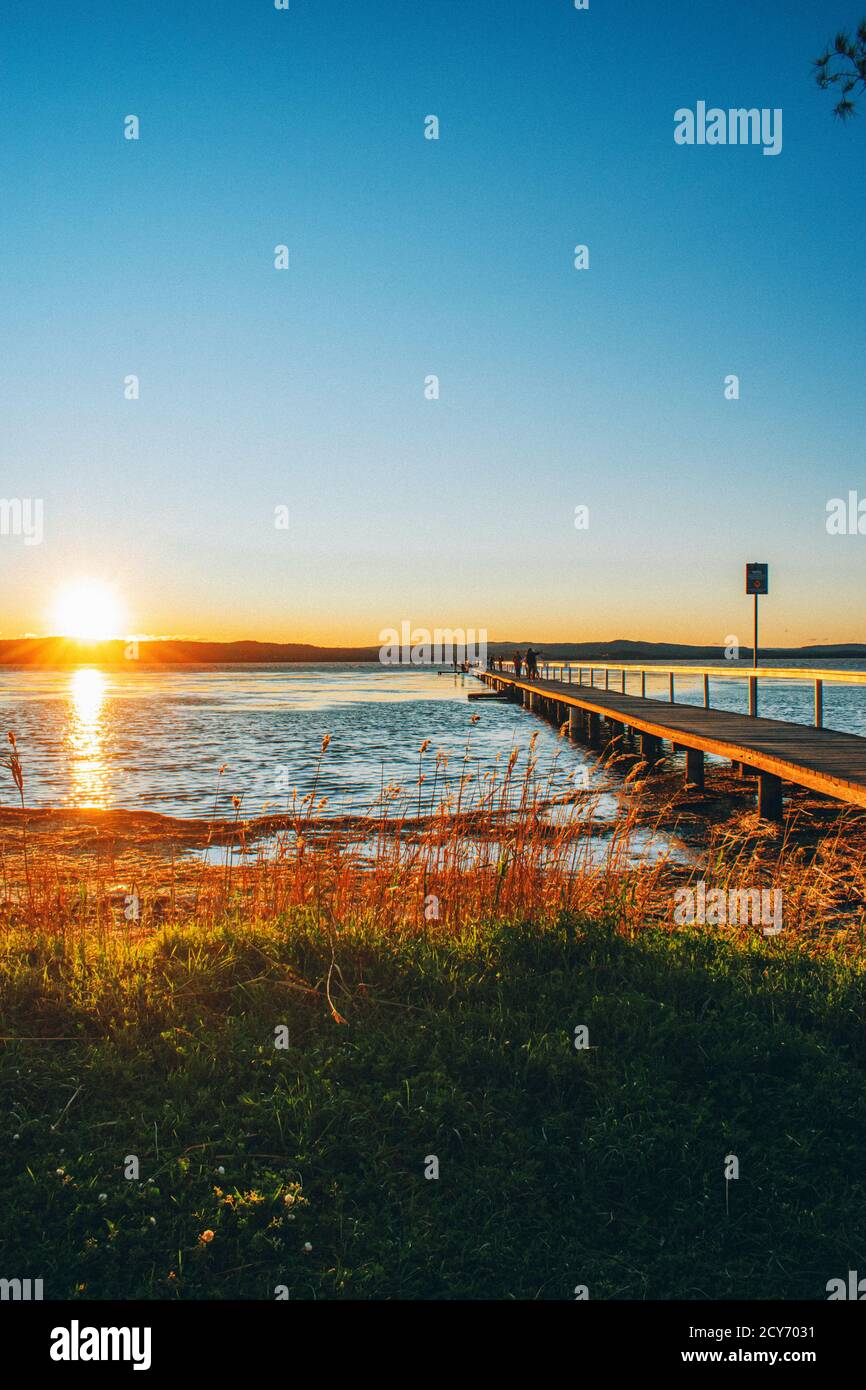 Beautiful sunset scenery over a pier in a lake Stock Photo - Alamy