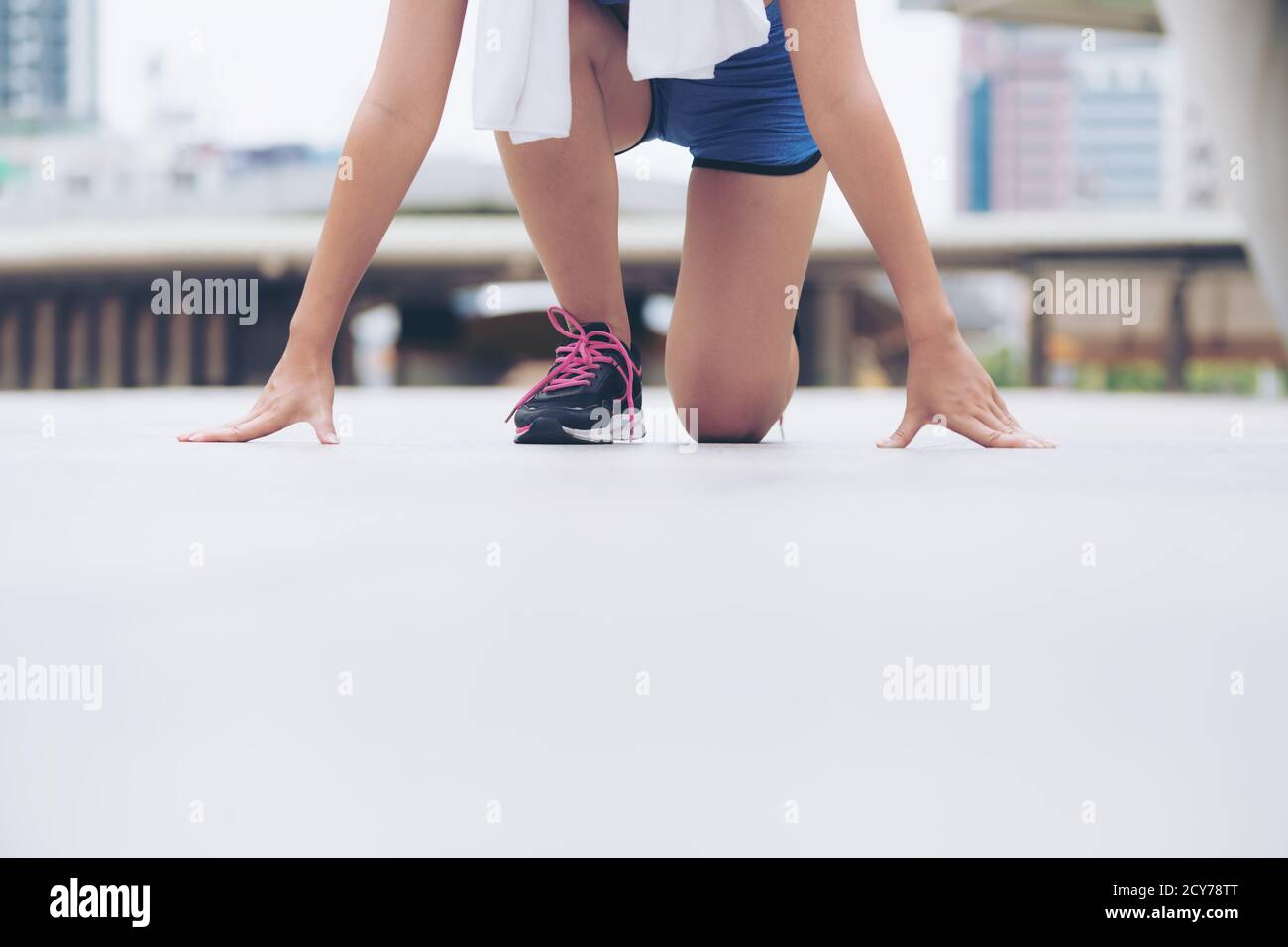 Sport woman runner in starting run position, ready to start running ...