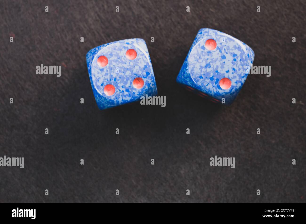 Top view of two blue dice on a black surface Stock Photo - Alamy