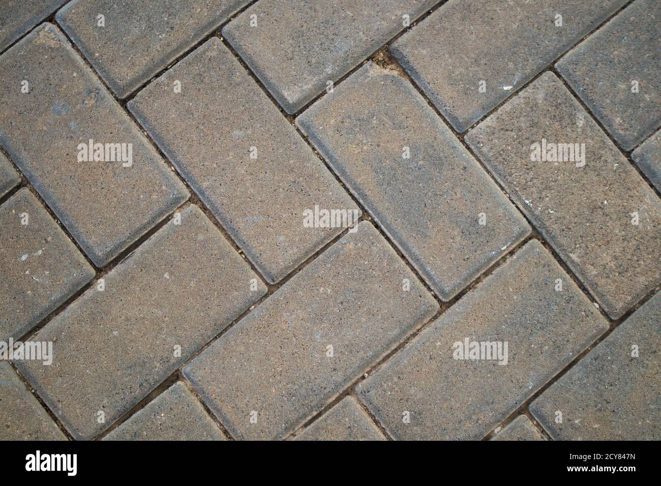 Bricks that form a diagonal tessellation on the ground of a walkway in ...