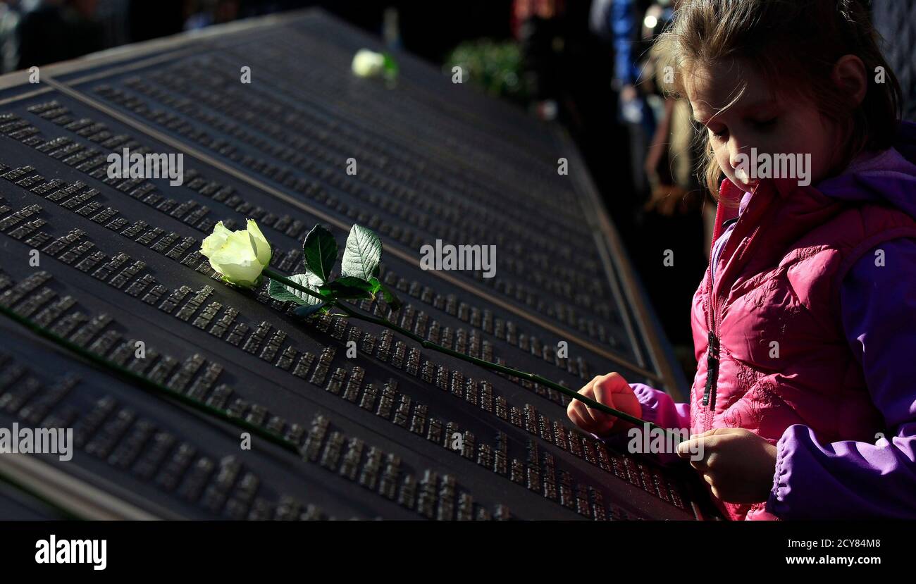 A Girl Places A Rose On A Plaque Bearing The Names Of Those Who Died When The Titanic Sank At a-girl-places-a-rose-on-a-plaque-bearing-the-names-of-those-who-died-when-the-titanic-sank-at