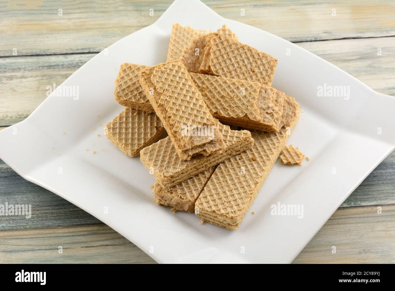 Broken wafer cookies damaged by poor packaging on dessert plate Stock ...