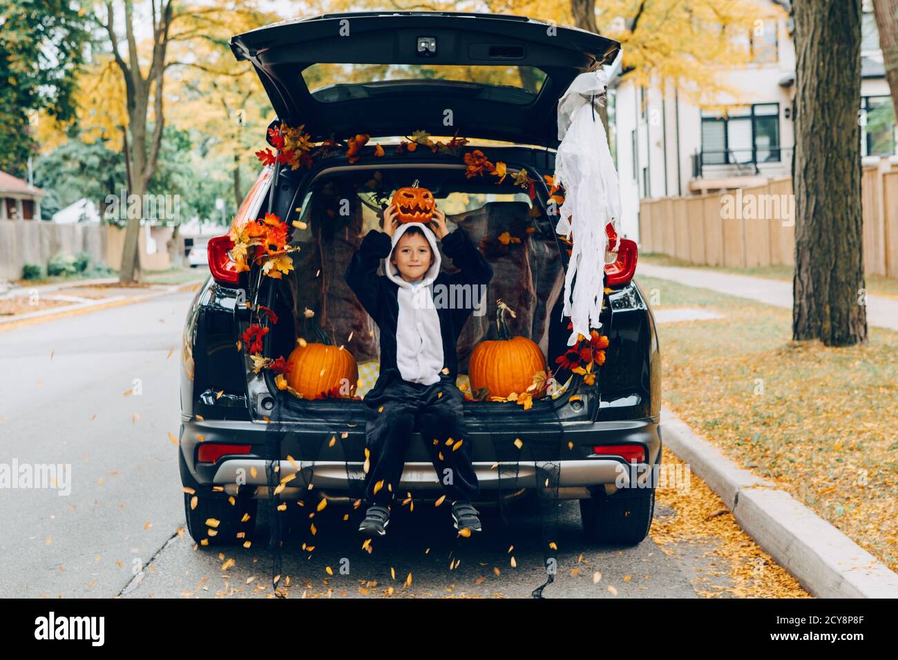 Trick or trunk. Child boy celebrating Halloween in trunk of car. Kid ...