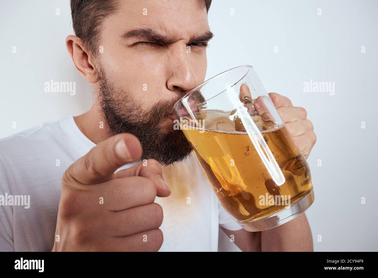 emotional man with a large mug of beer alcoholic drink gesturing with ...
