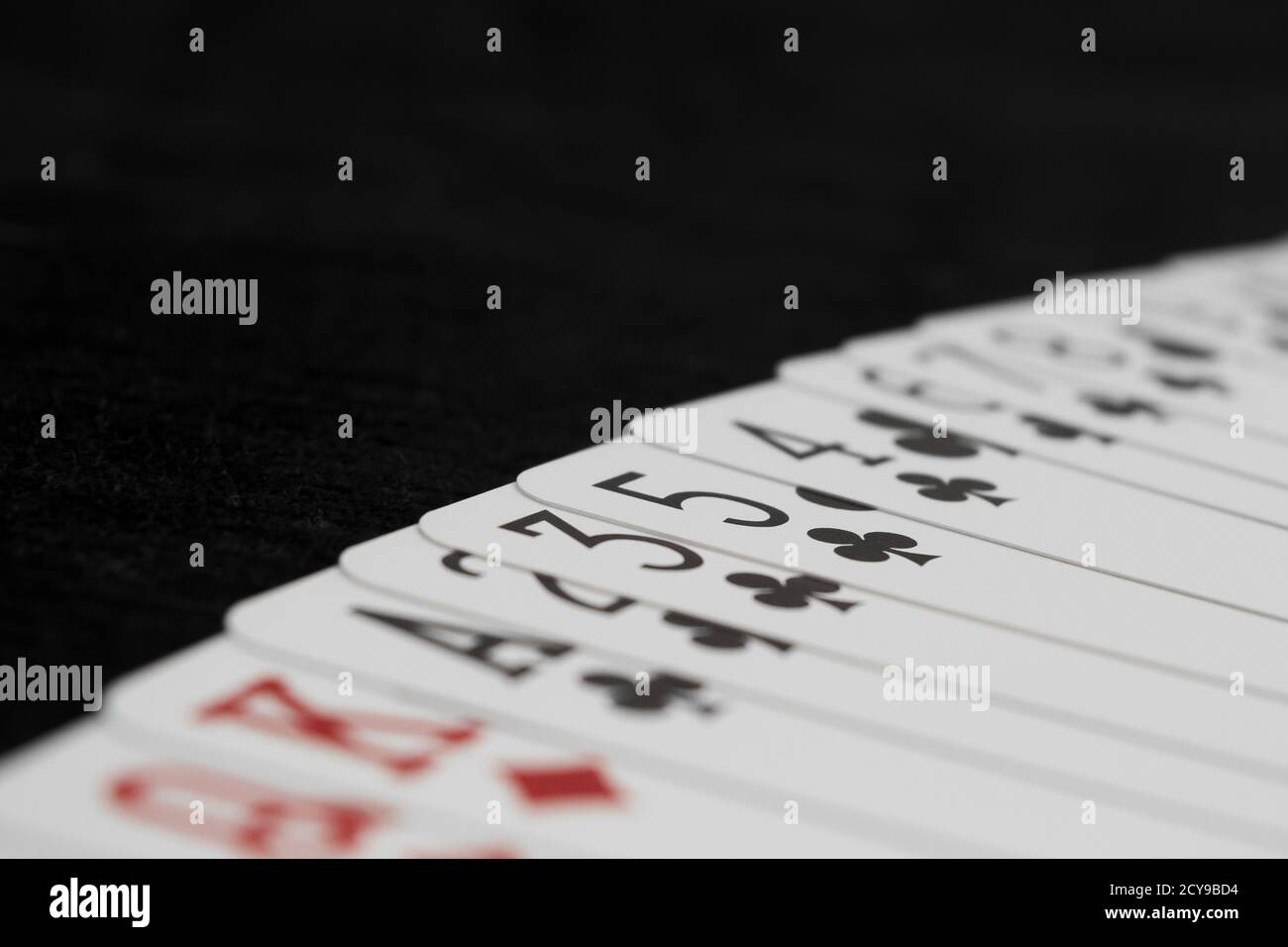 Closeup of playing cards next to each other on a black background Stock ...
