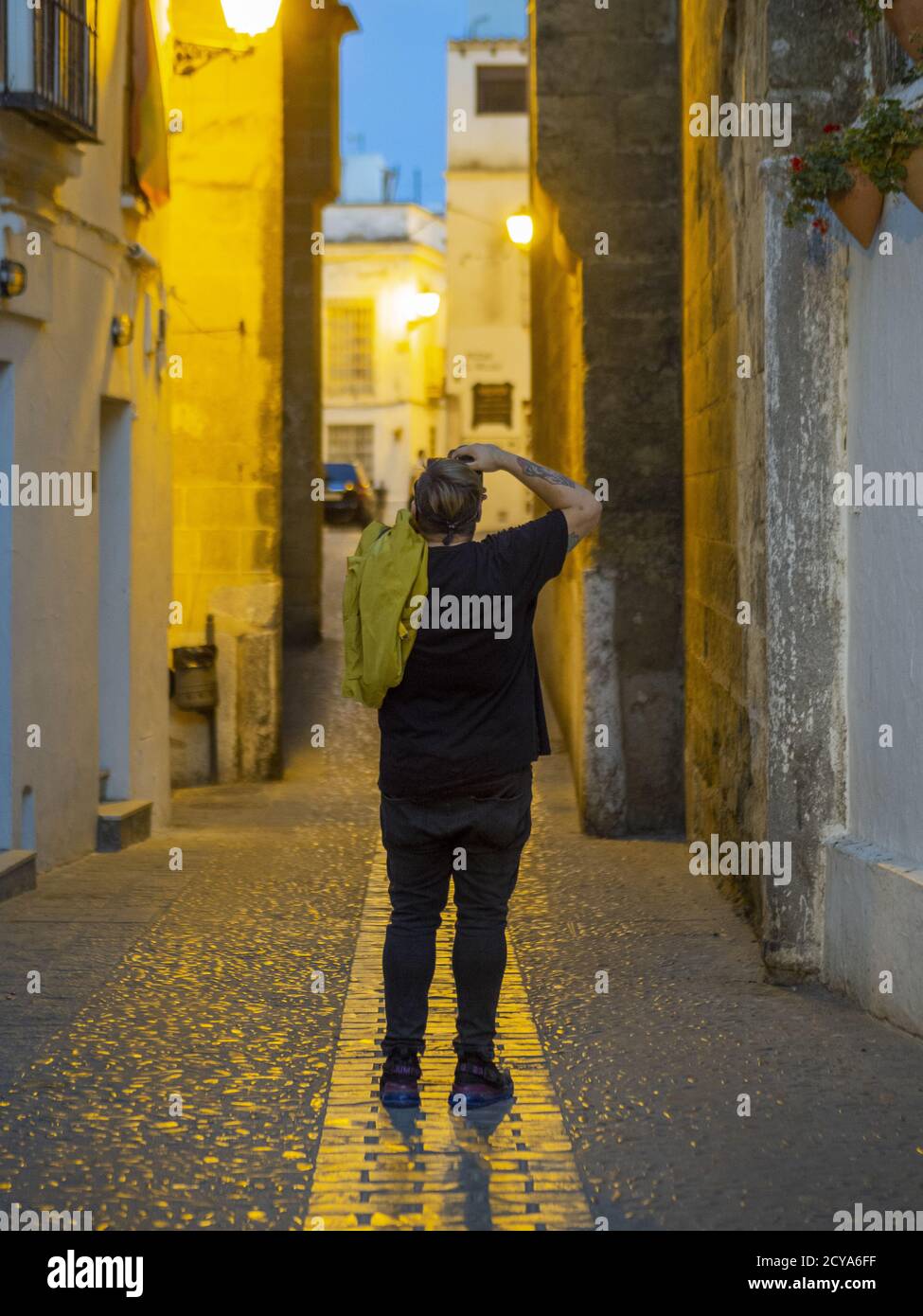 Photographer taking a photo of the buildings gleaming in the evening ...