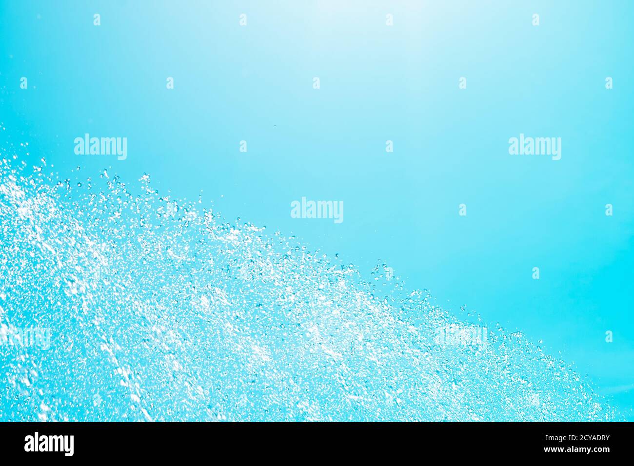 Splashing drops on the blue background Stock Photo - Alamy