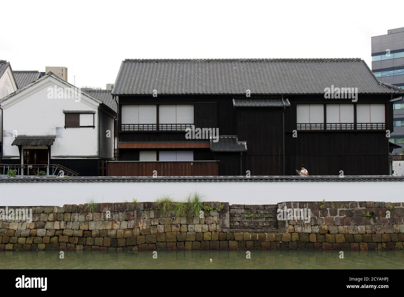 Tourist reading map around Dejima embarkment wall in Edo period in ...