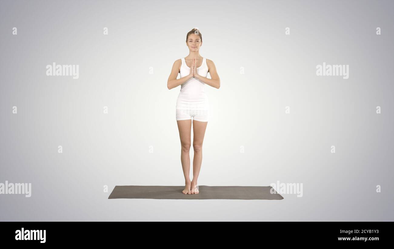 Young yoga woman meditating standing on gradient background Stock Photo ...