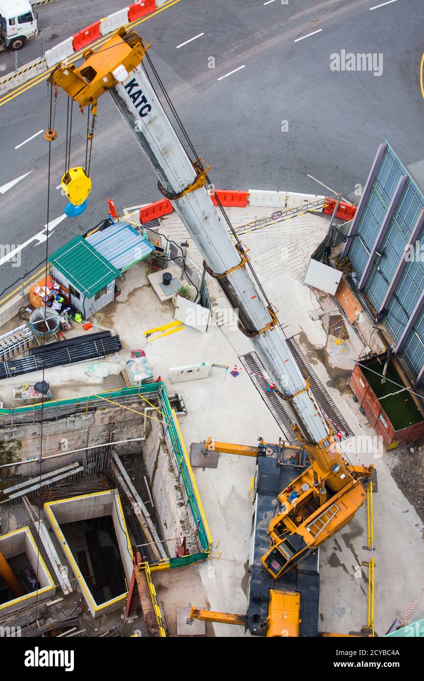 Aerial vertical view of a crane in extension on a construction site ...