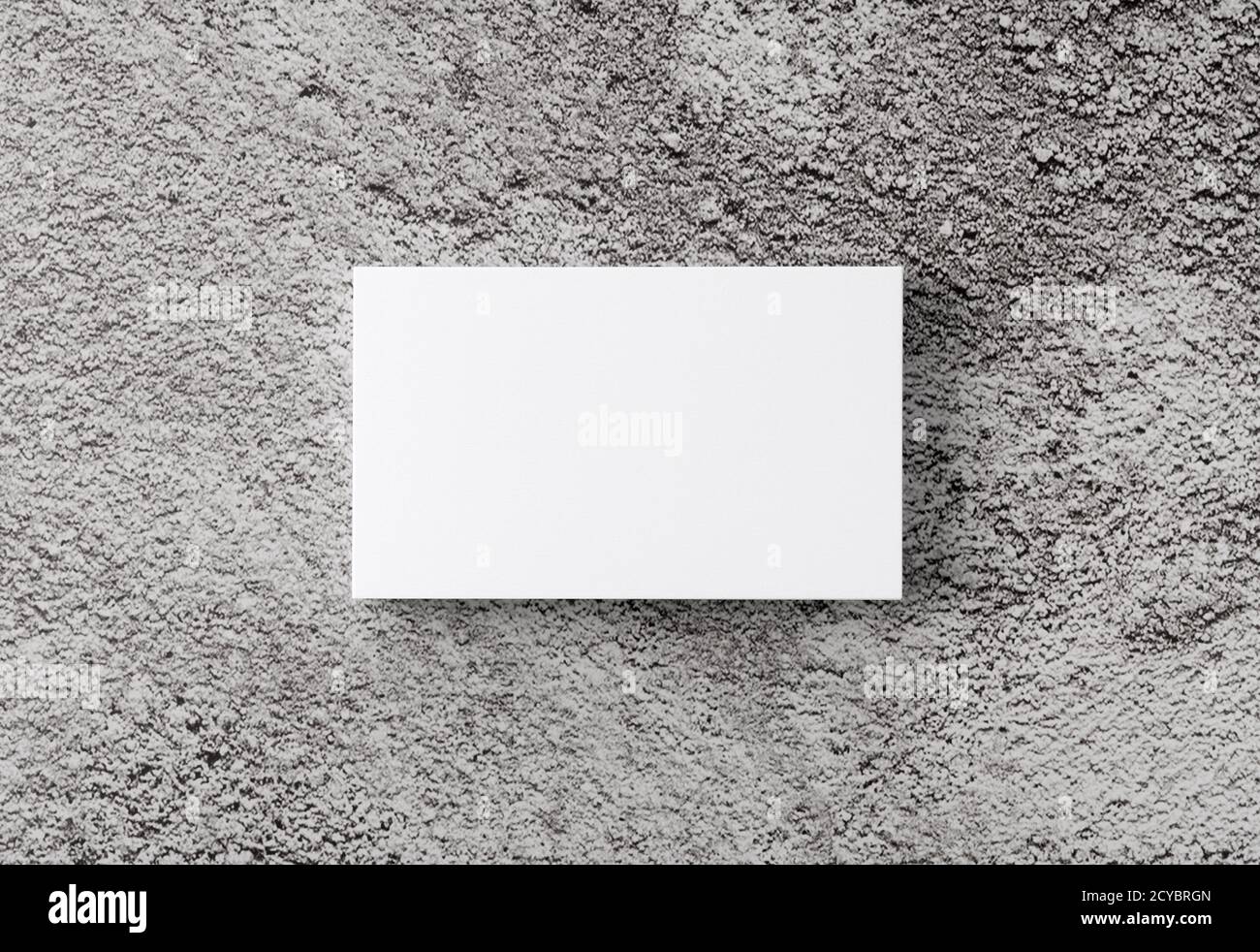 A business card placed against a stone background. Overhead shot Stock ...