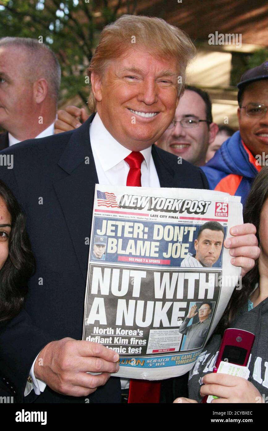 Donald Trump holding up the New York Post and posing with fans after ...