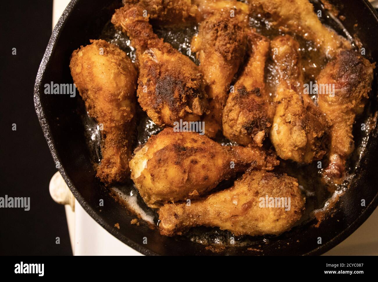 Chicken frying in a skillet Stock Photo - Alamy