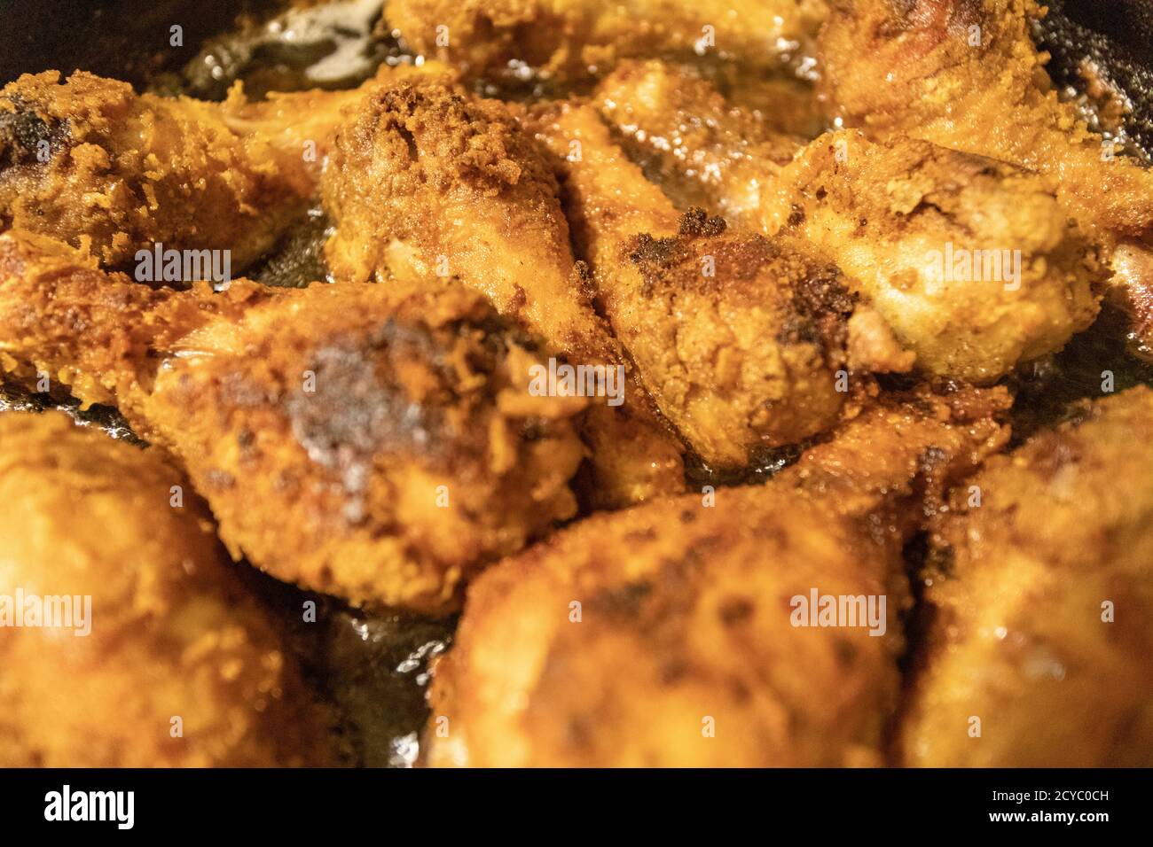 Chicken frying in a skillet Stock Photo - Alamy
