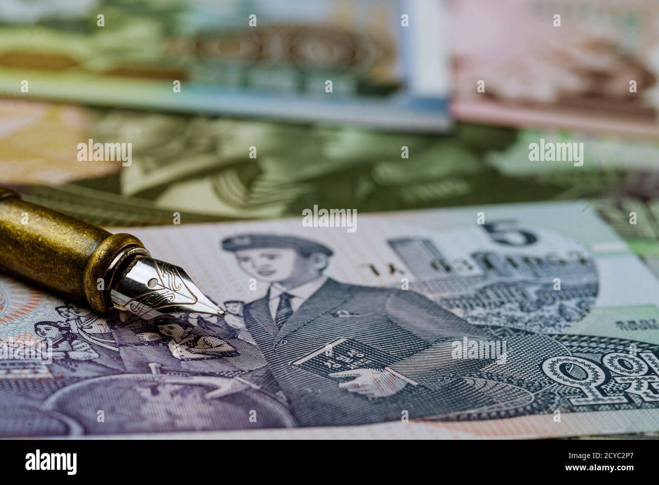 Various currency bill banknotes money won of North Korean KPW over pen ...