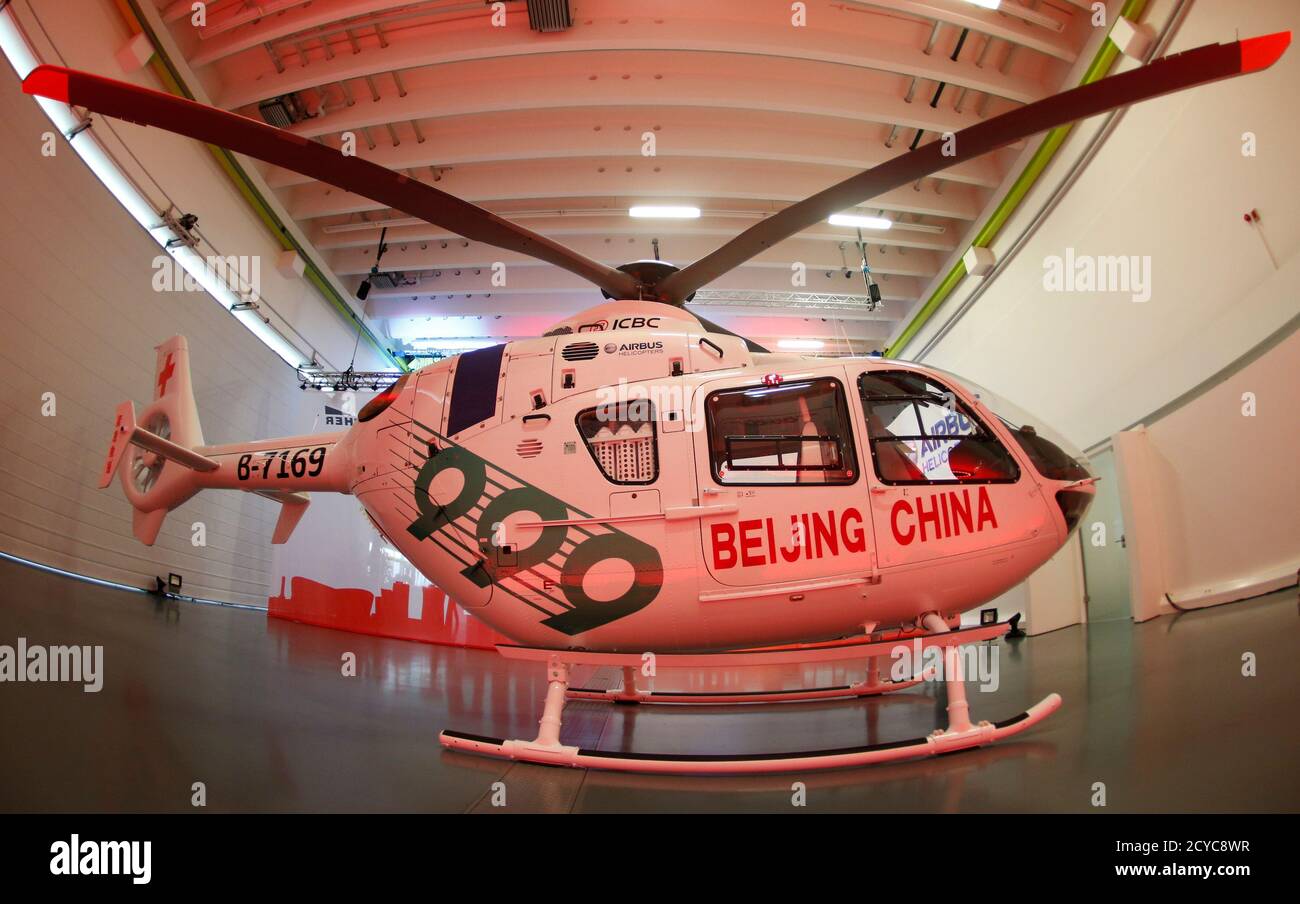 A twin-engine EC135 Airbus helicopter stands in a hangar prior to the ...