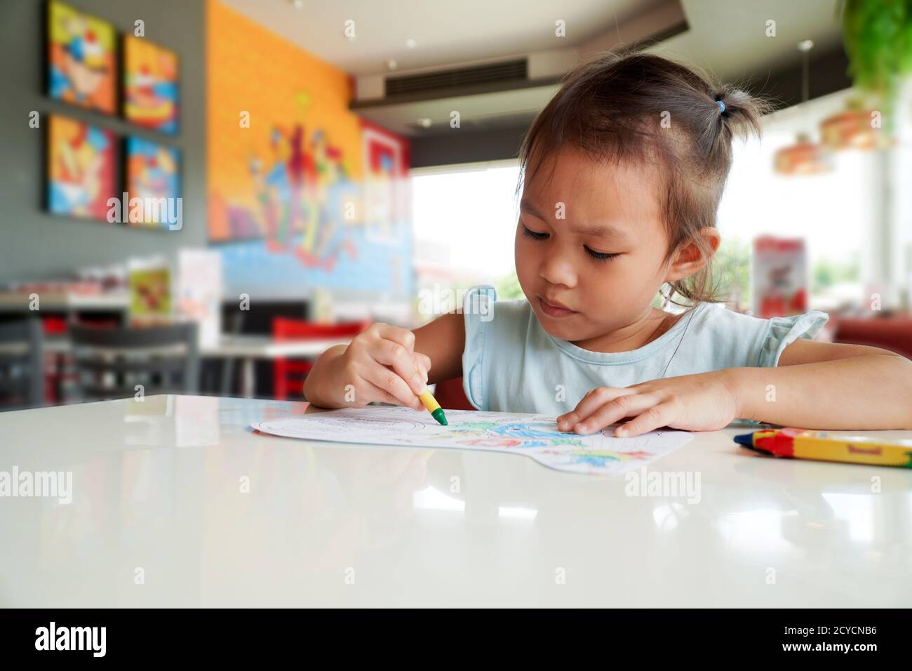 Little child intend coloring with crayons in the classroom Stock Photo ...
