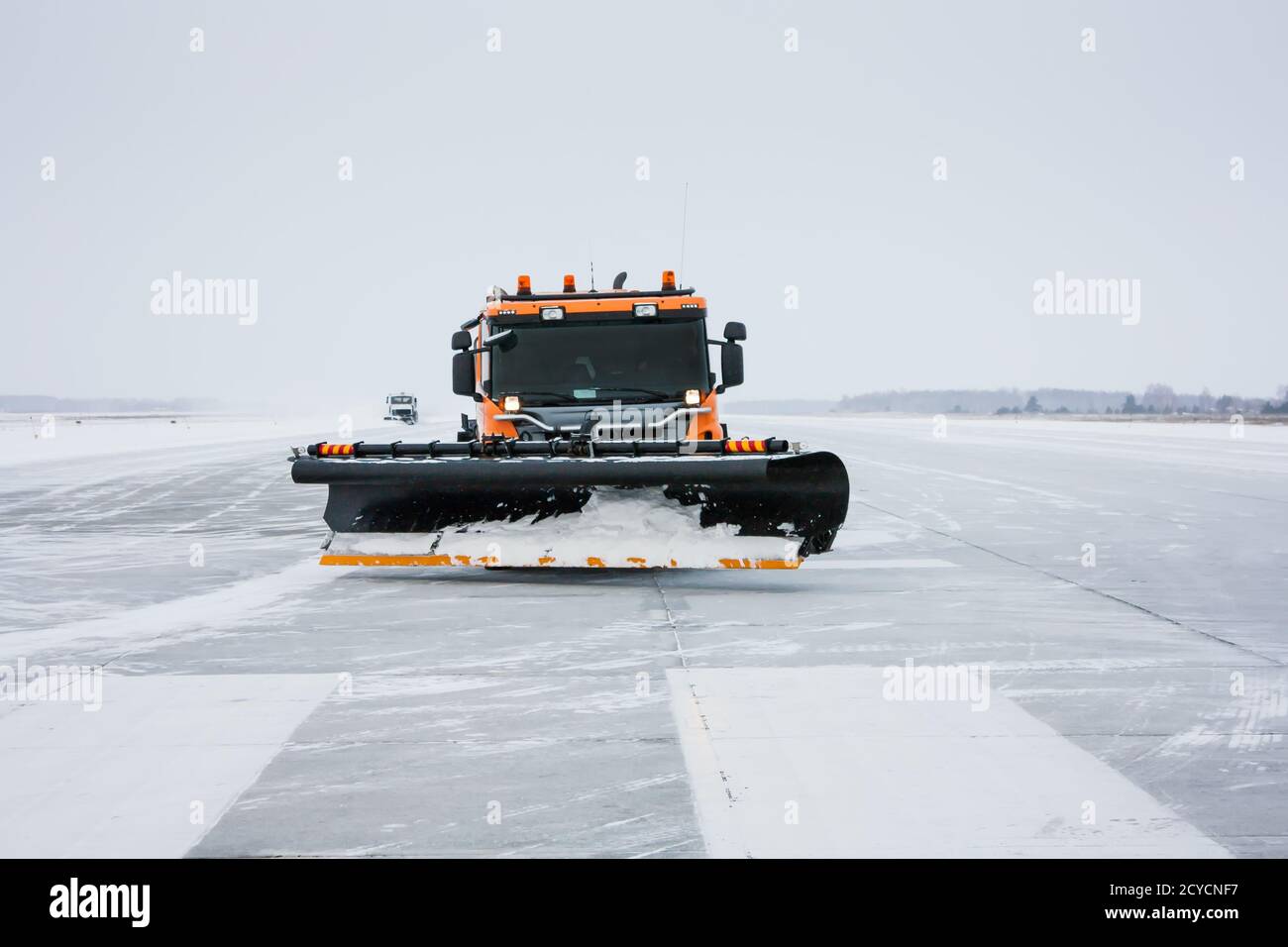 Snow machines on the winter runway Stock Photo - Alamy
