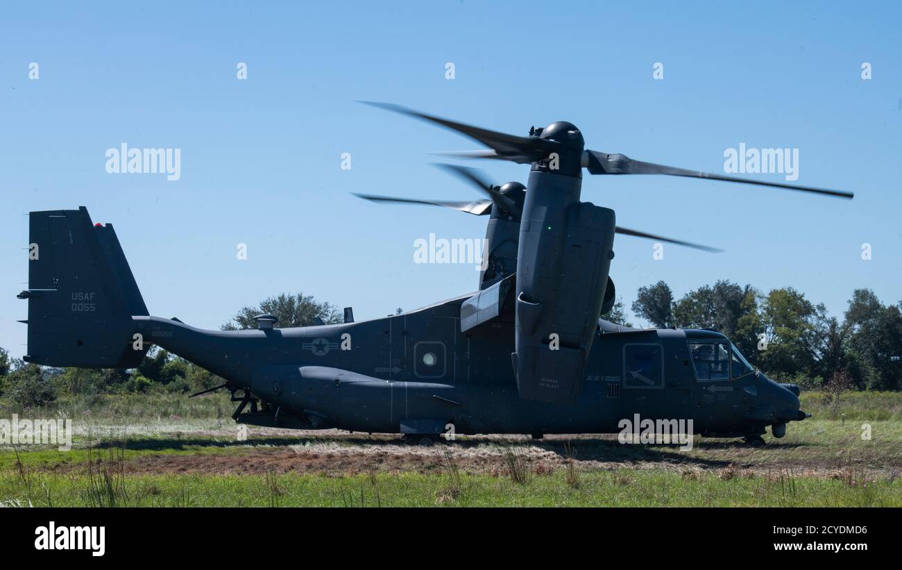 A CV-22B Osprey tiltrotor aircraft rests in a field at Malone, Florida ...