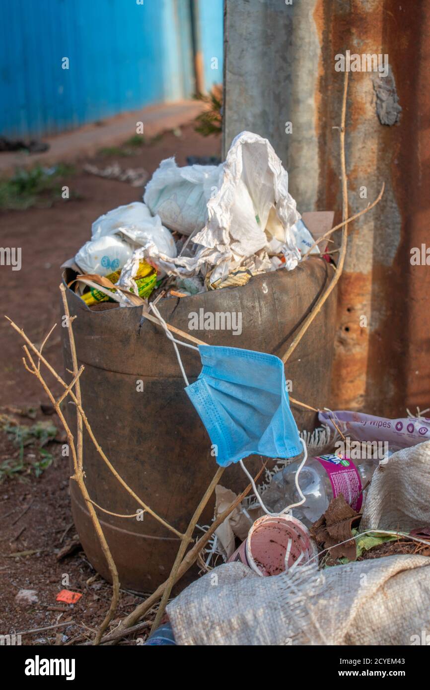 used face mask thrown in the trash bin Stock Photo - Alamy