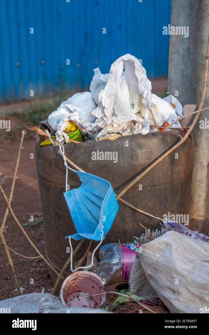 used face mask thrown in the trash bin Stock Photo - Alamy