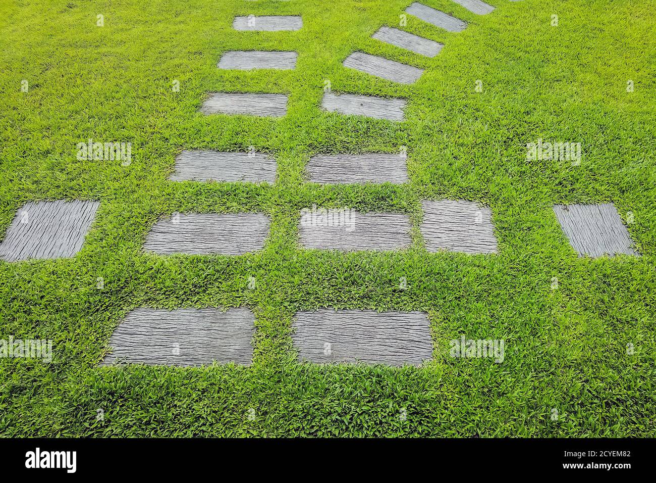 Walkway sheet stretching into the distance with green grass lawn in ...