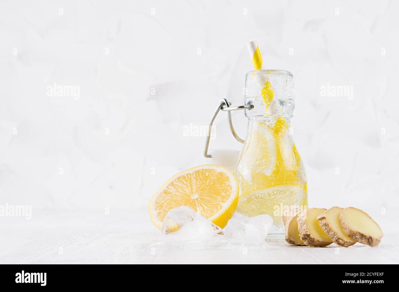 Summer homemade drink - infused lemon water with ice cubes, ginger ...