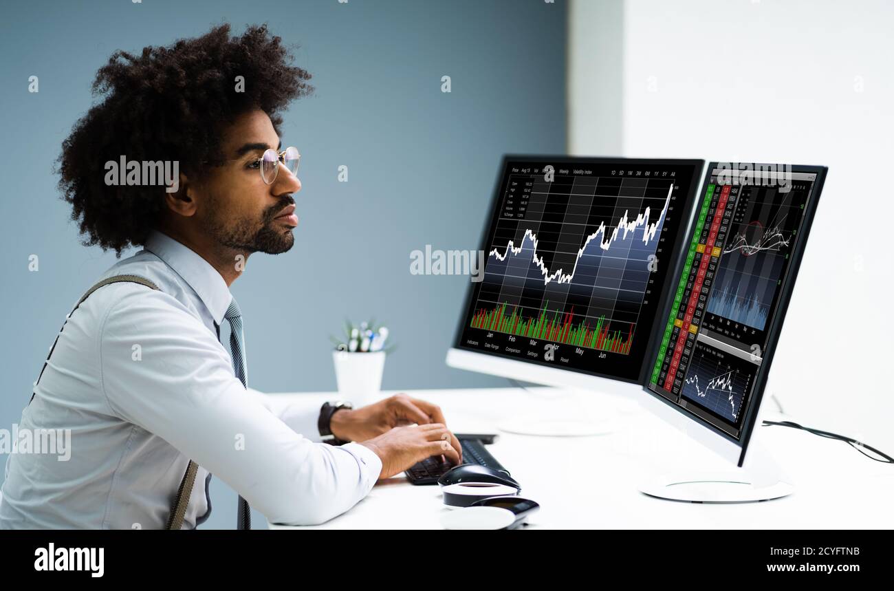 Stock Exchange Analyst Using Multiple Computer Screens Stock Photo - Alamy