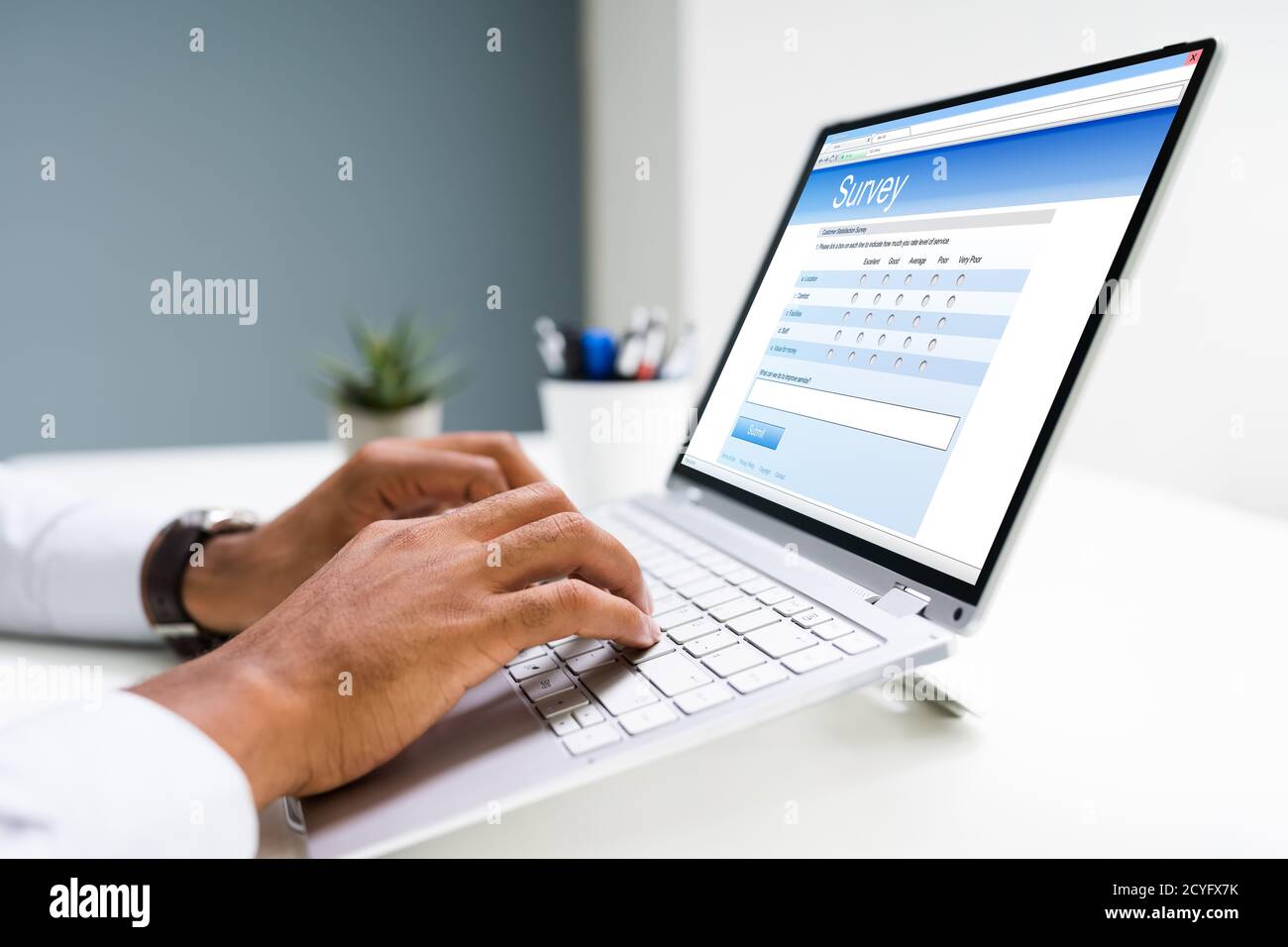 Man Filling Online Survey Form On Laptop Computer Stock Photo - Alamy