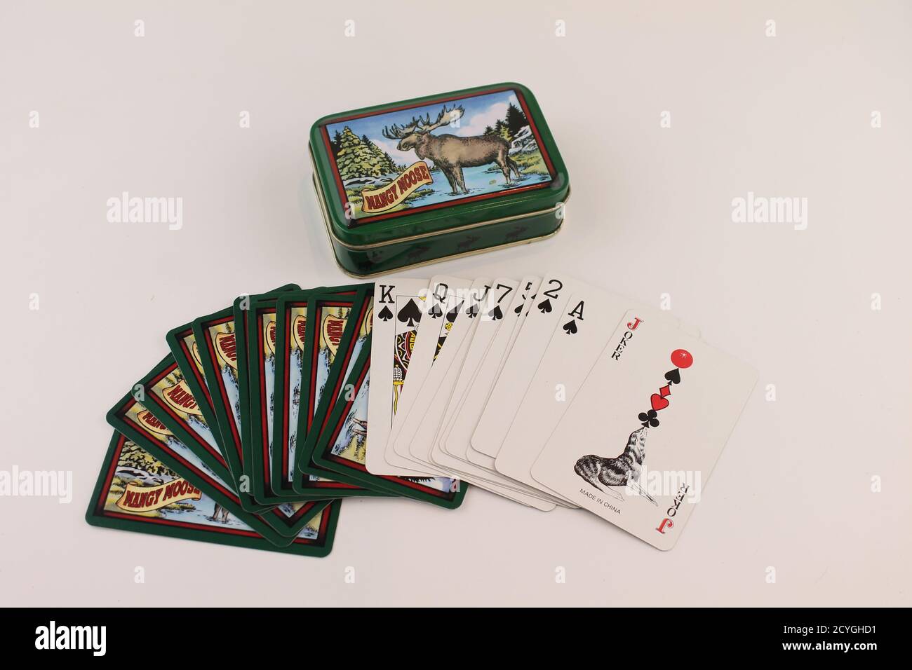 Mangy Moose playing cards in a fan with metal tin advertising an ...