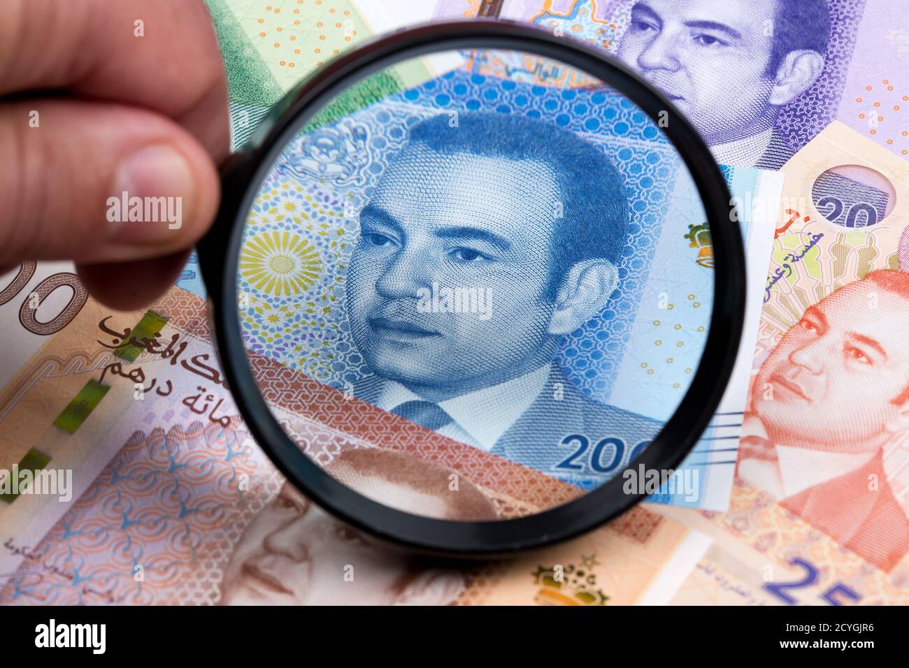 Moroccan dirham in a magnifying glass a business background Stock Photo - Alamy