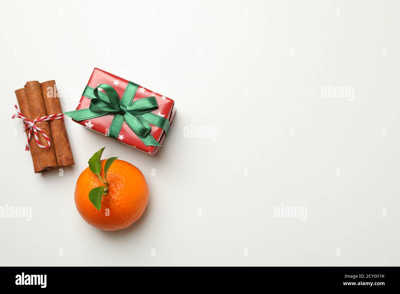 Mandarin, cinnamon and gift box on white background Stock Photo - Alamy