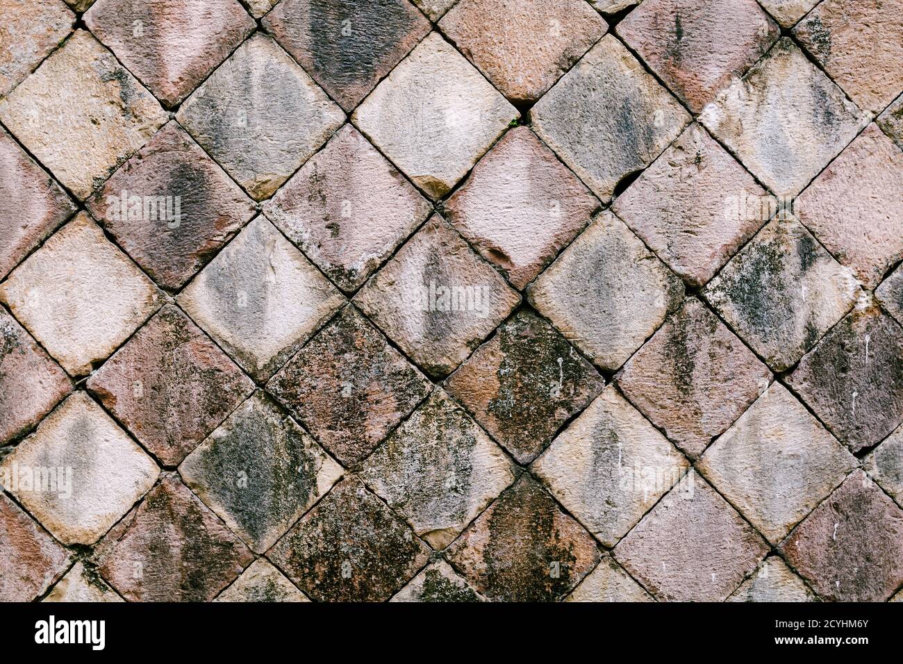 Old paving stones made of gray natural stone with scuffs and streaks ...