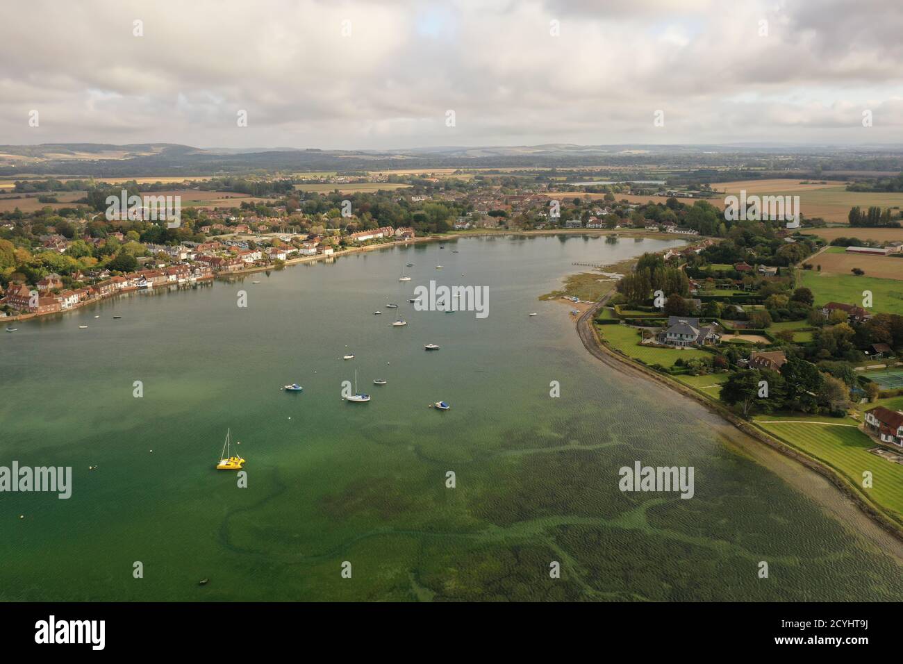 Bosham Harbour at high tide with boats at anchor and the beautiful ...