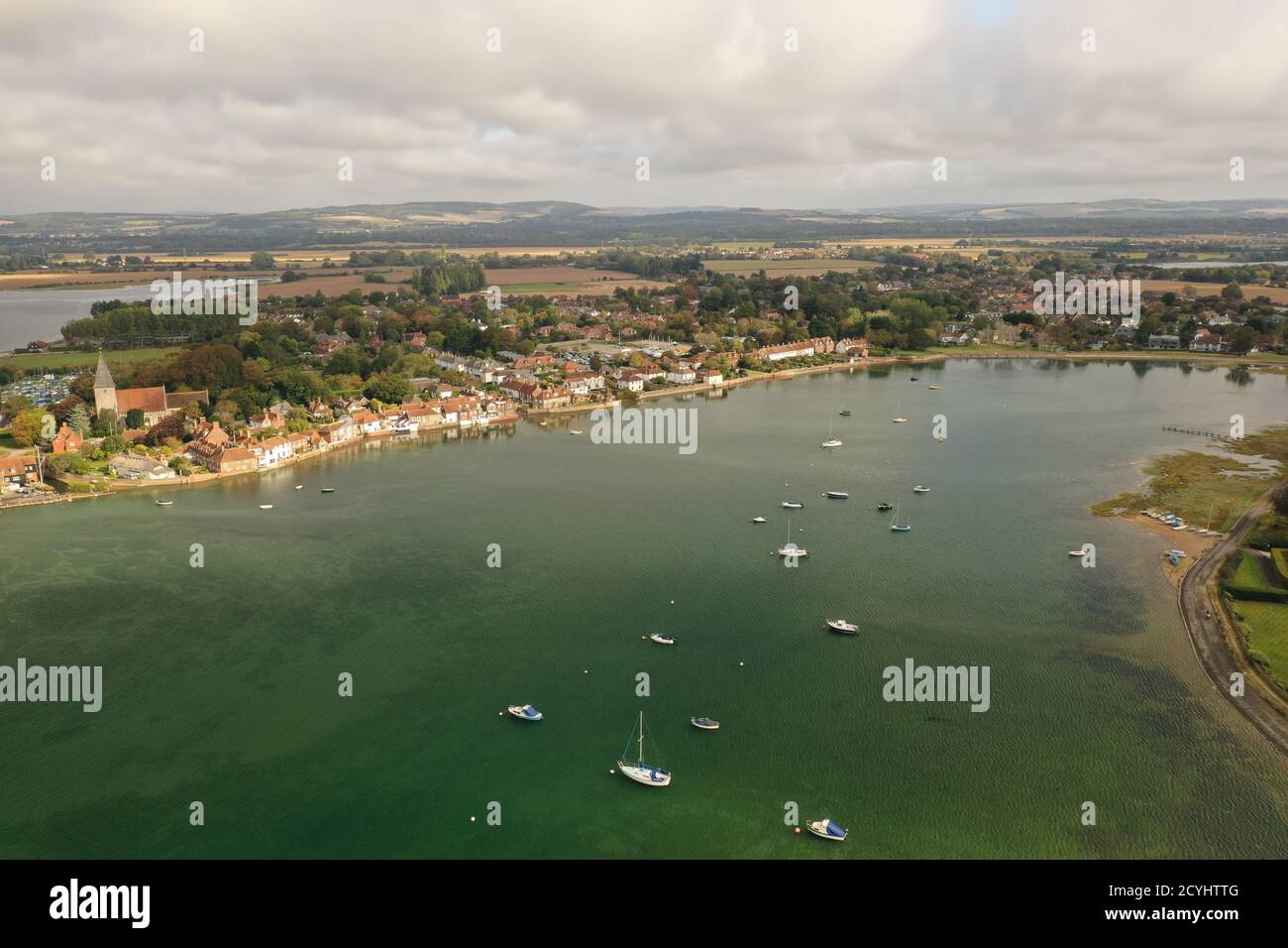 Bosham Harbour and Village with boats at anchor and the beautiful ...