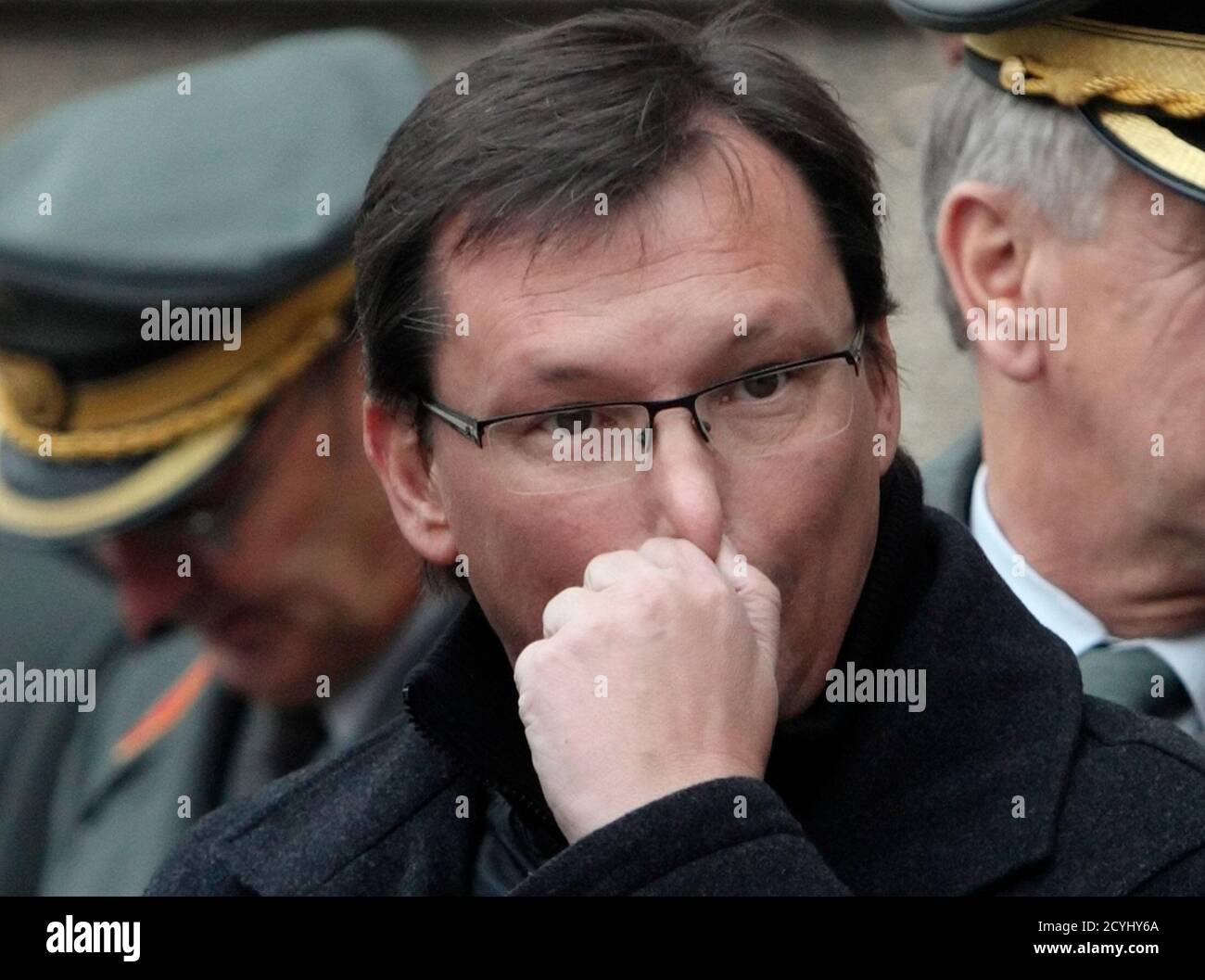Austrian Defence Minister Norbert Darabos grabs his nose during a ...
