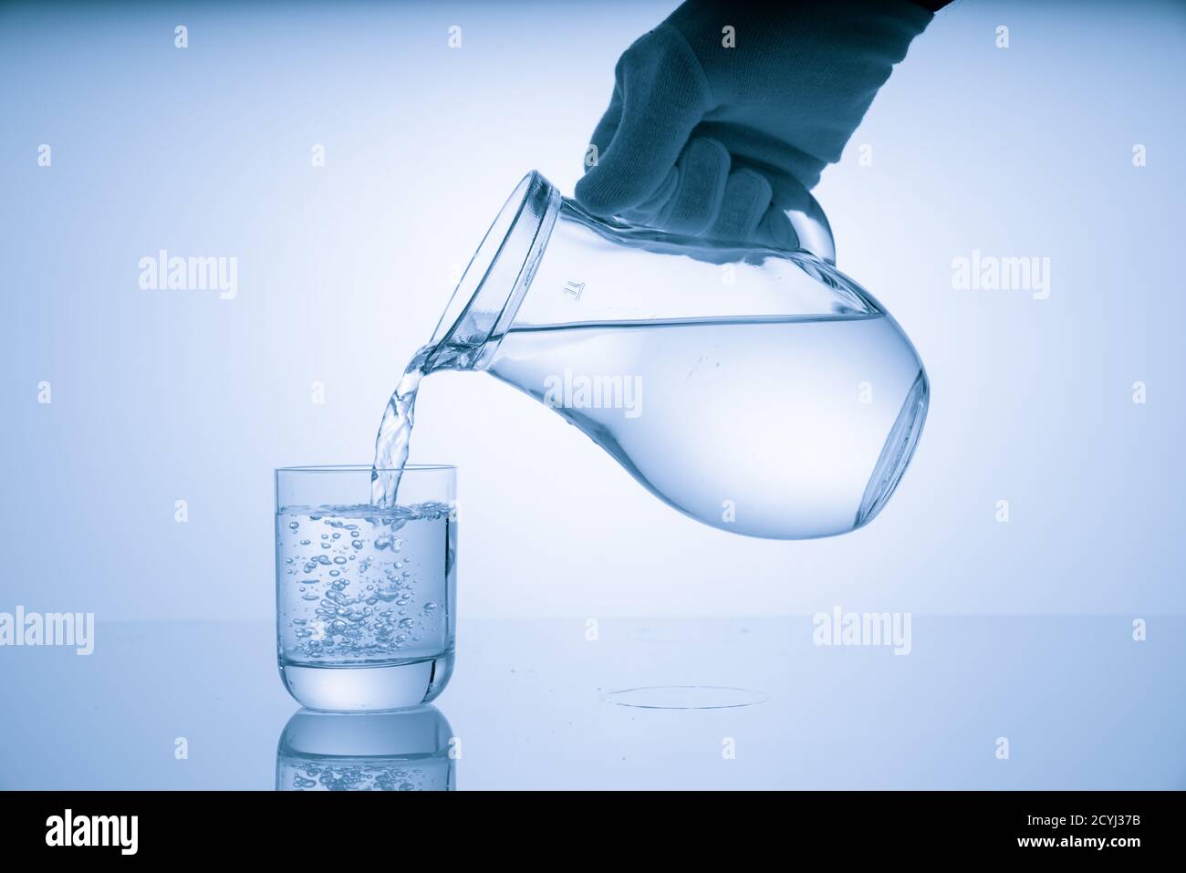 Pitcher with drinking water and a glass with a drink, blue tone Stock ...