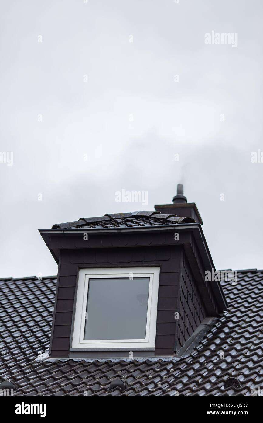 Vertical shot of a dormer window on the roof on a gloomy day Stock ...