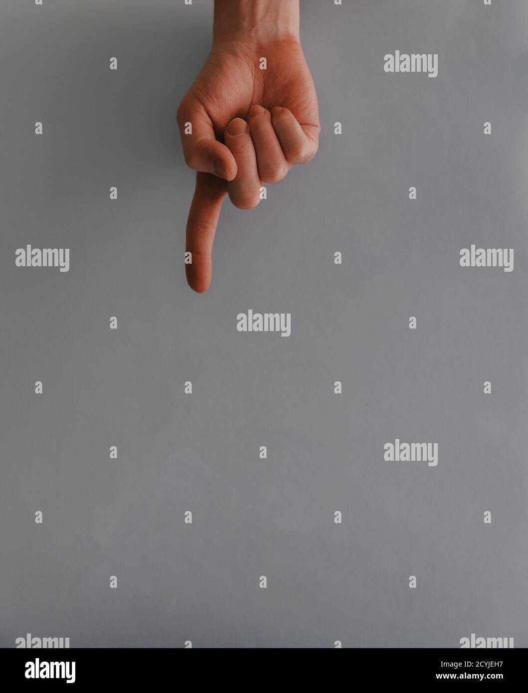 Vertical shot of a hand showing "down Stock Photo - Alamy
