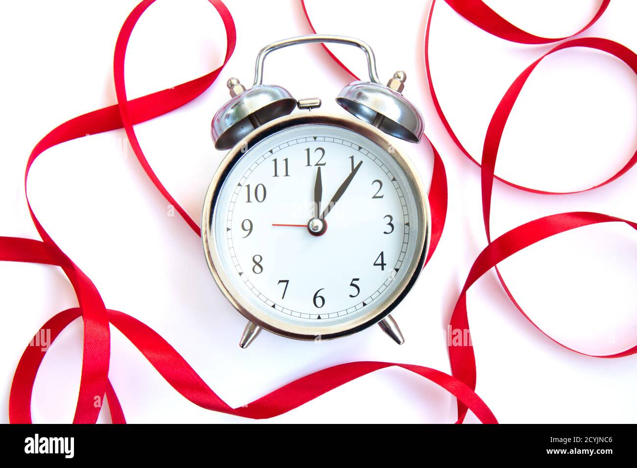 Bright festive red ribbon, curl and a beautiful vintage silver alarm ...