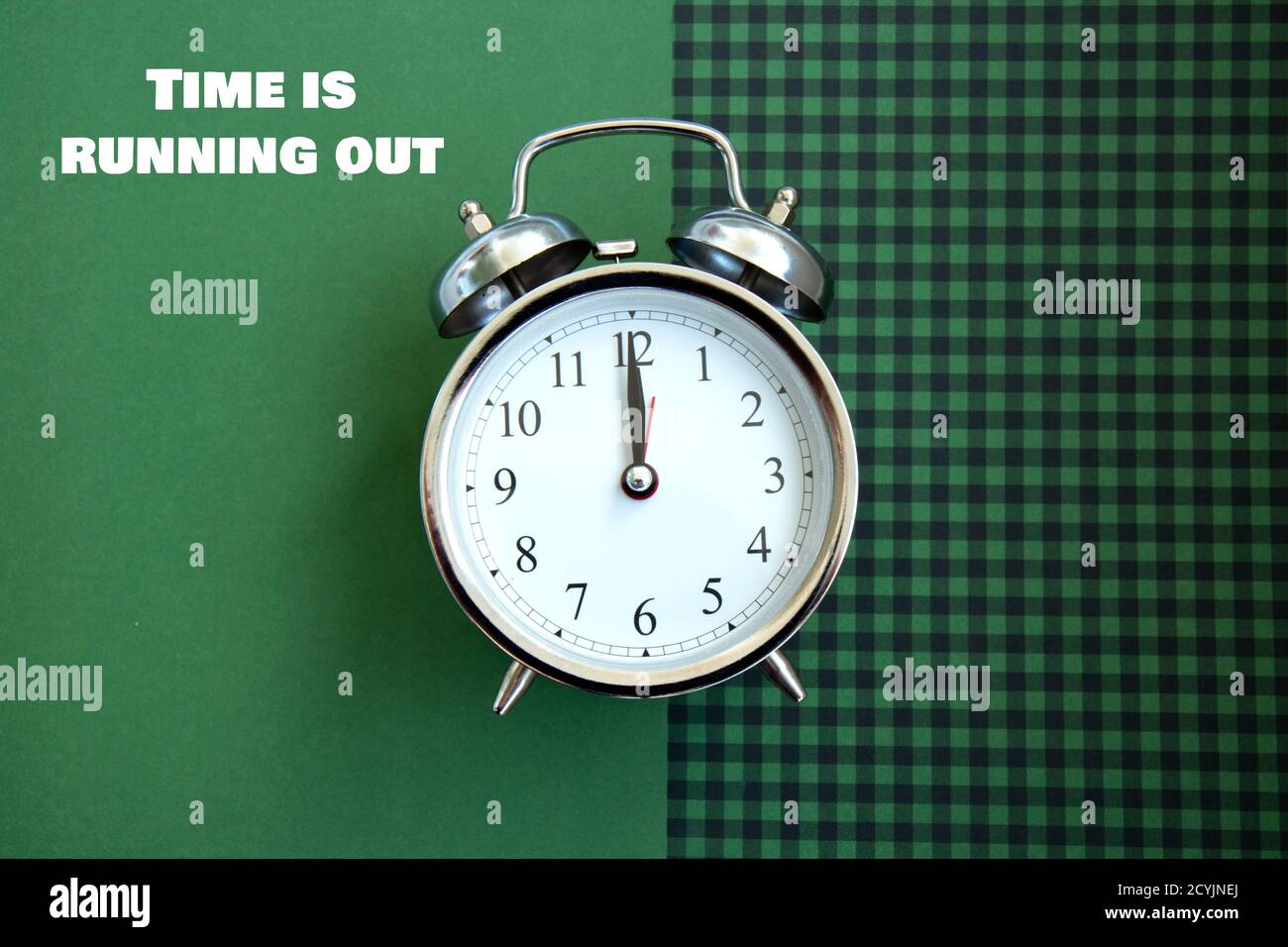 Beautiful vintage silver alarm clock on a green checkered background ...