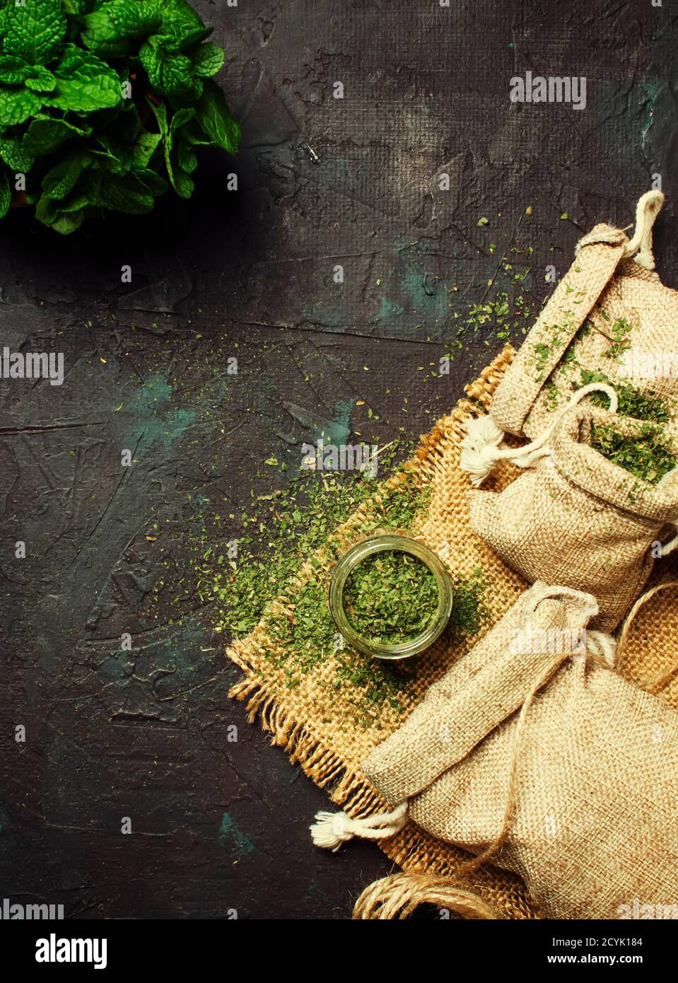 Dried peppermint in a glass jar and a bunch of fresh mint, medicine ...