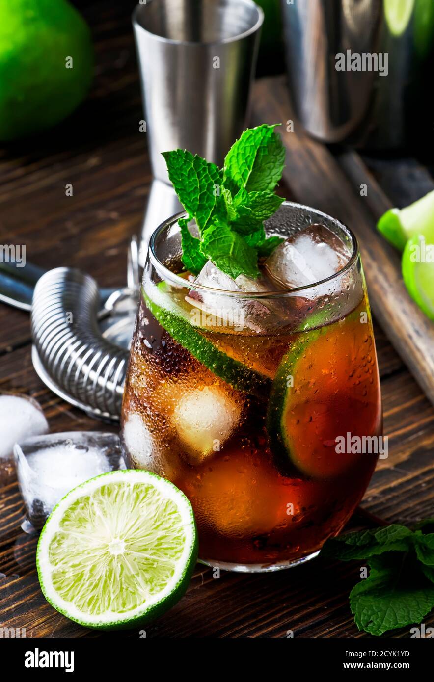 Cuba libre alcohol cocktail with golden rum, lemon juice, cola, lime ...