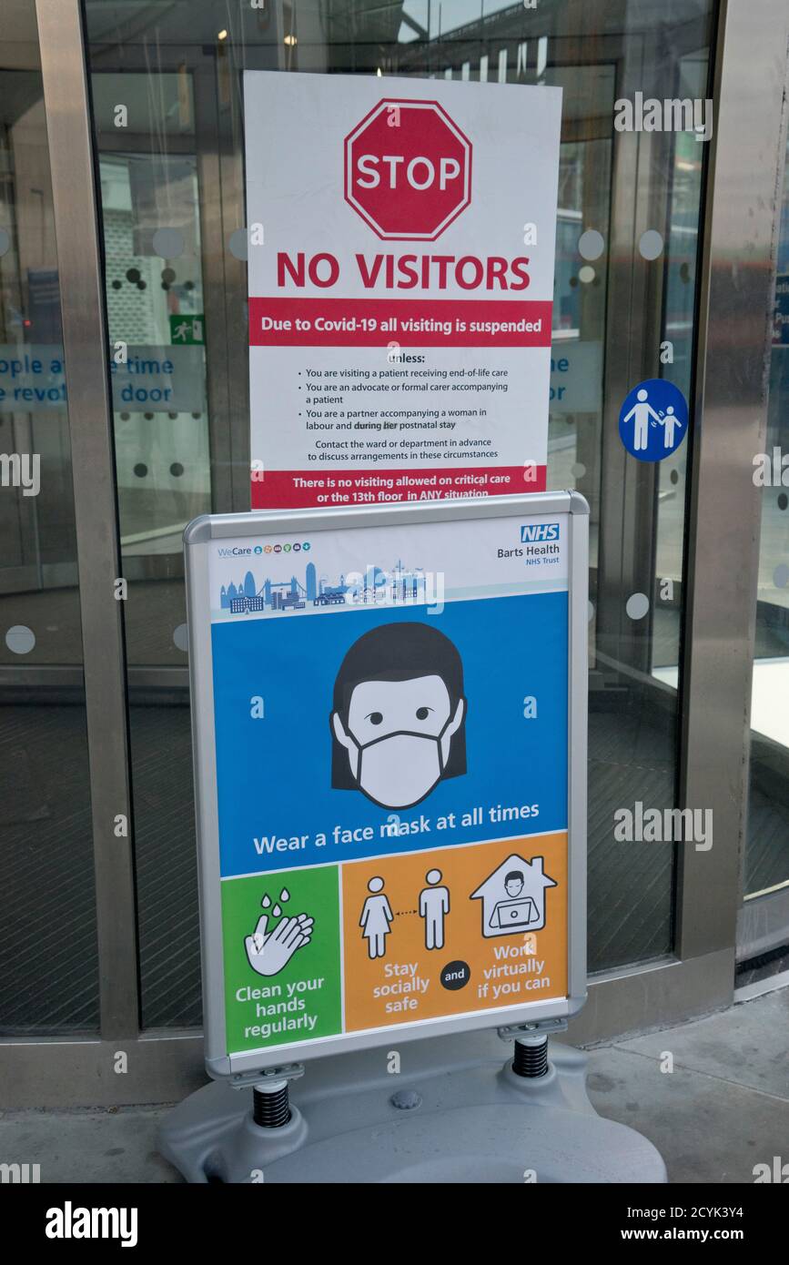 Signs advising visitors to stay away or to keep safe social distance ...