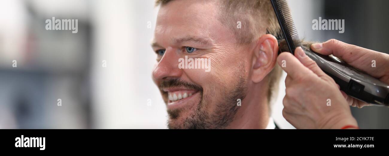 Barber cuts man in beauty hi-res stock photography and images - Alamy