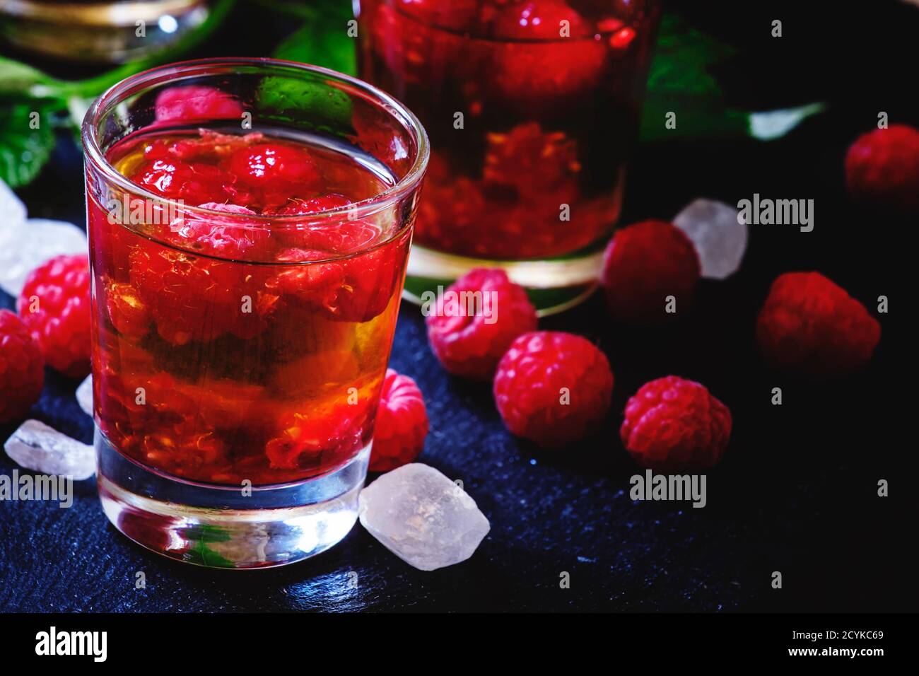 Alcoholic cocktail with strong alcohol, syrup and fresh raspberries ...