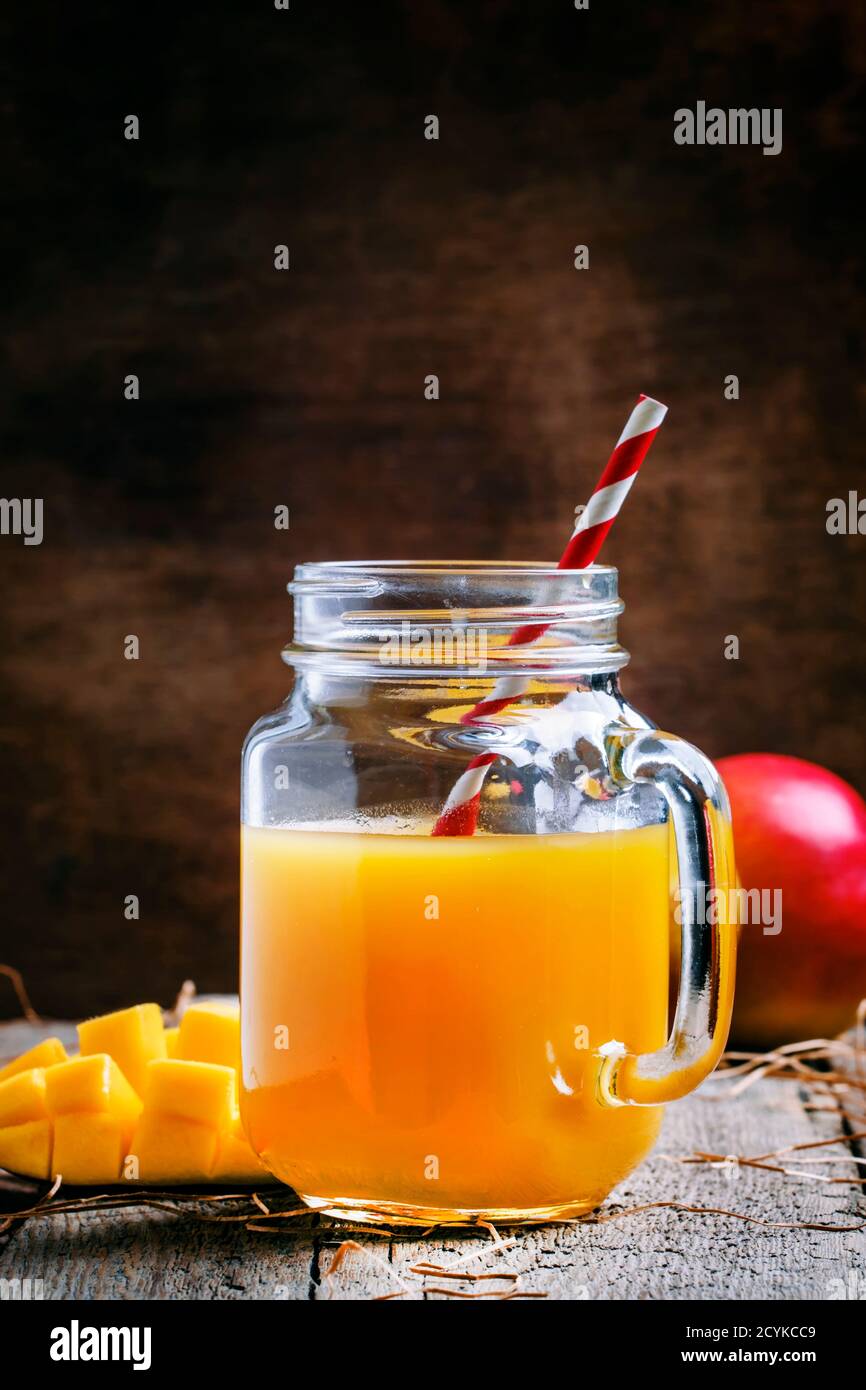 Mango juice with straw on old wooden background, selective focus Stock ...