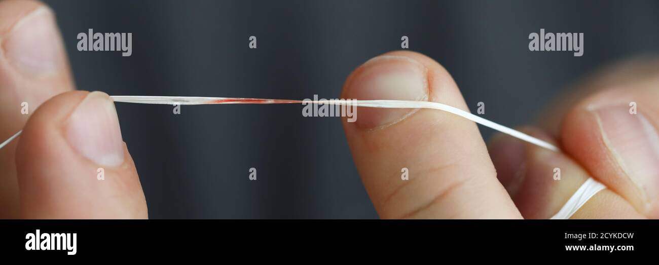 Hold dental floss with blood in your hands Stock Photo - Alamy