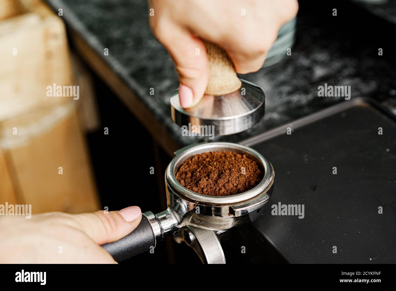 Woman coffee shop worker preparing coffee on professional coffee ...