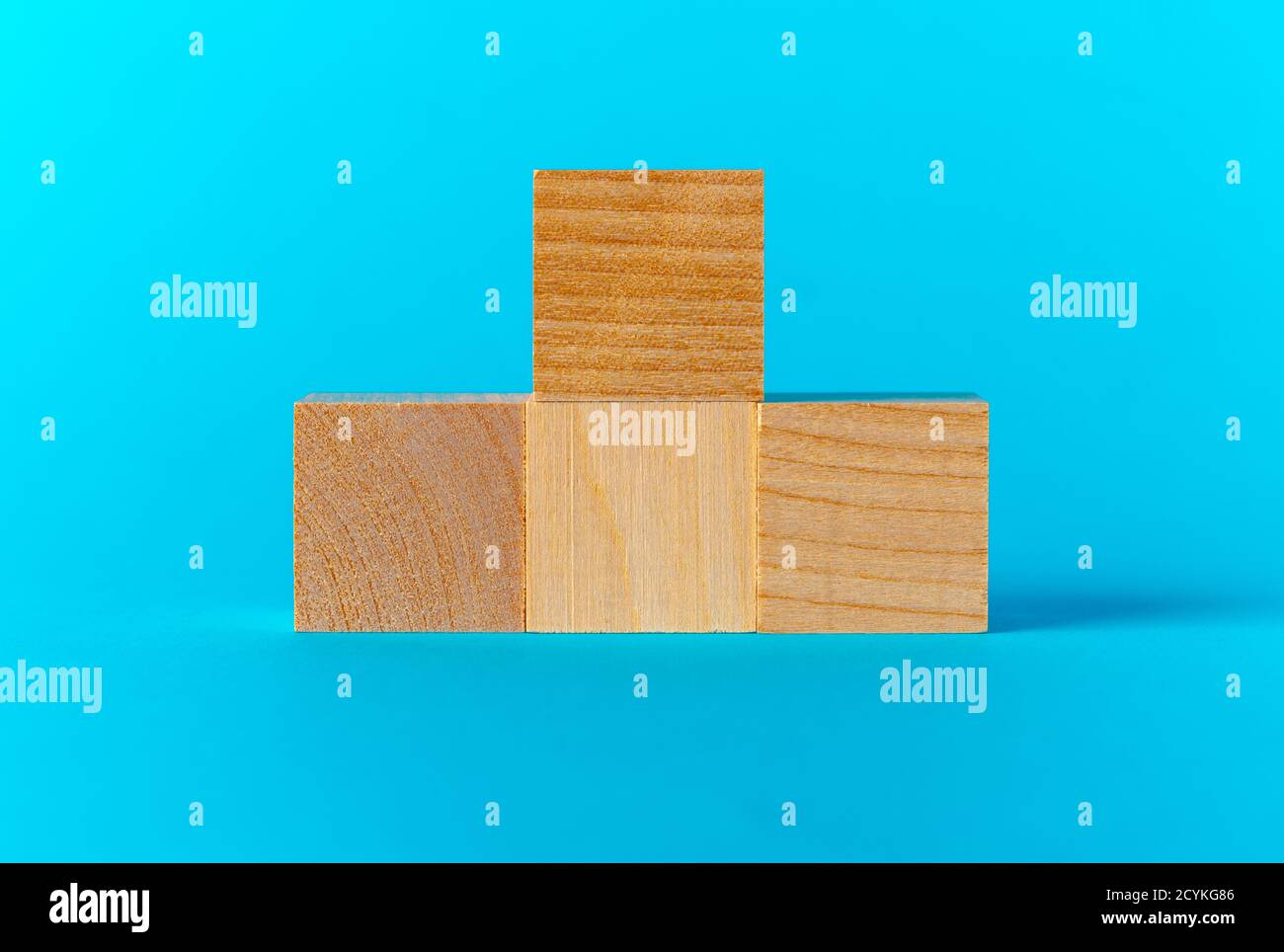 Toy wooden blocks on blue background front view Stock Photo - Alamy